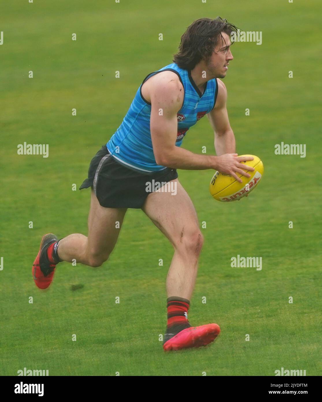 Andrew McGrath runs with the ball during an Essendon Bombers AFL ...