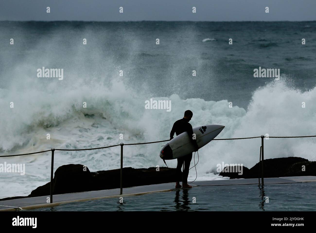 A surfer prepares to enter the surf at Bronte Beach in Sydney, Friday ...