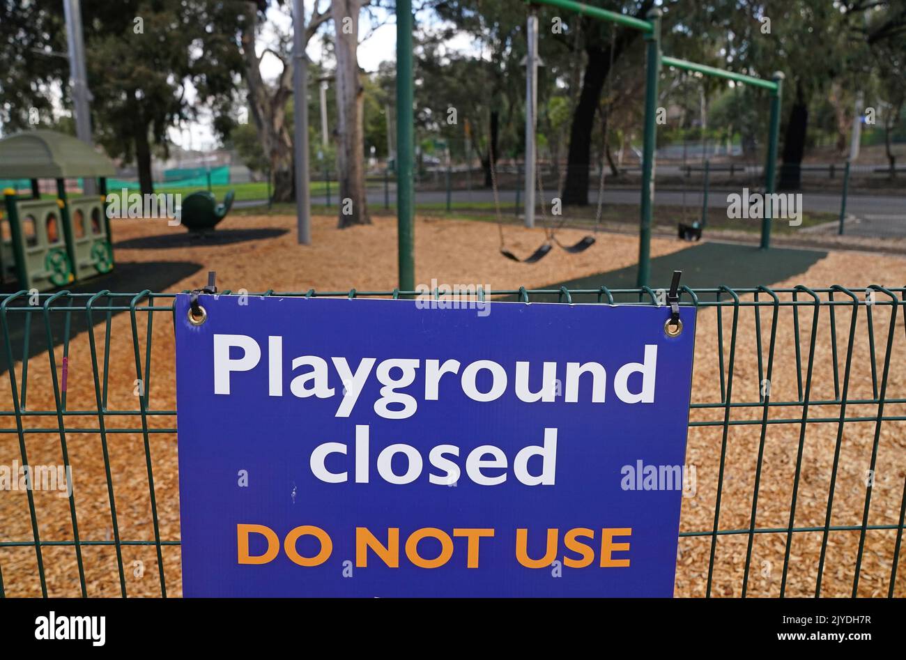 A playground closed sign is seen at a children’s playground in ...