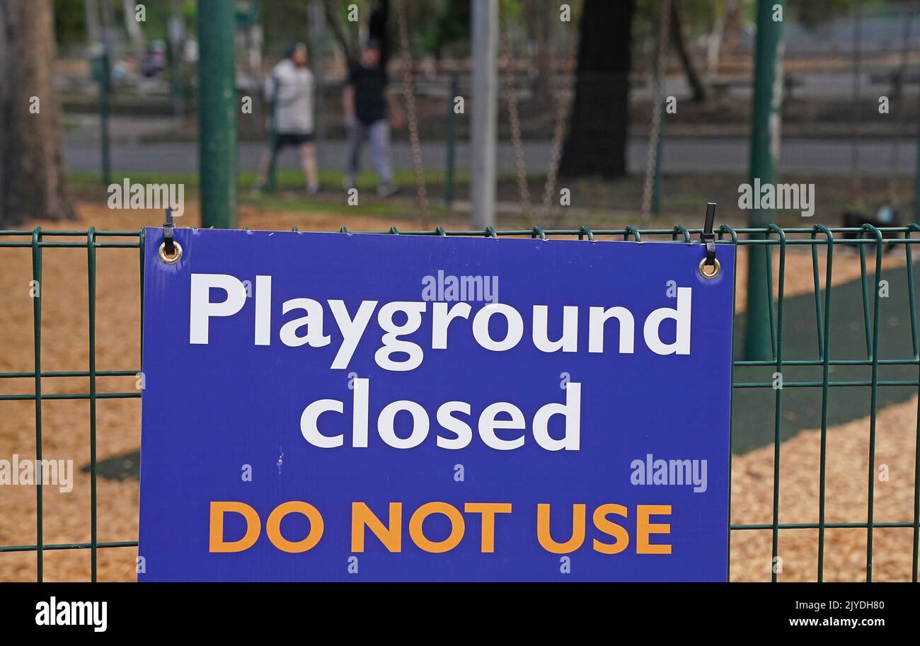 A playground closed sign is seen at a children’s playground in ...