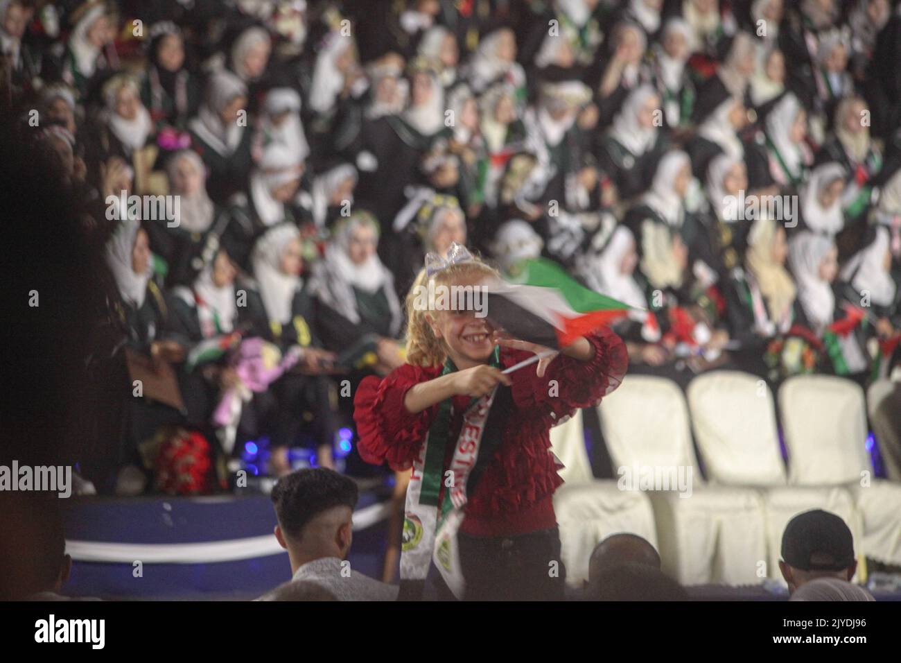 Palestinian students attend their graduation ceremony at Al-Quds Open ...