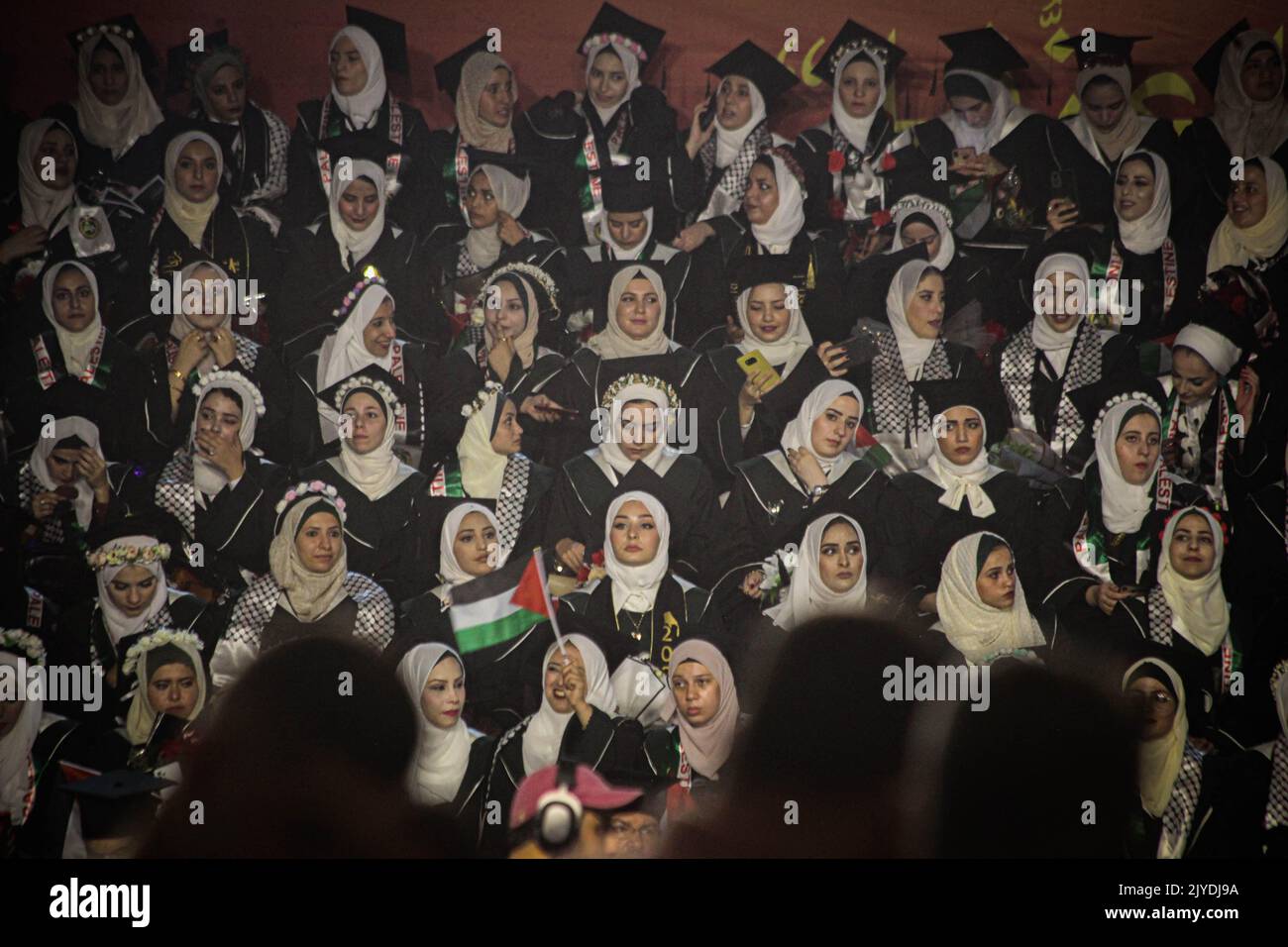 Palestinian students attend their graduation ceremony at Al-Quds Open ...