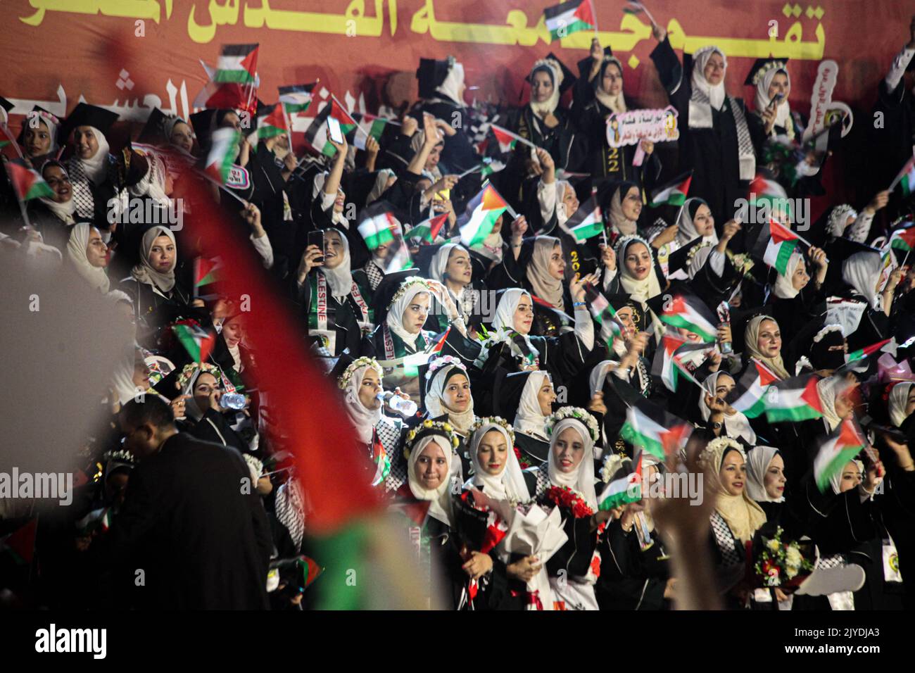 Palestinian students attend their graduation ceremony at Al-Quds Open ...