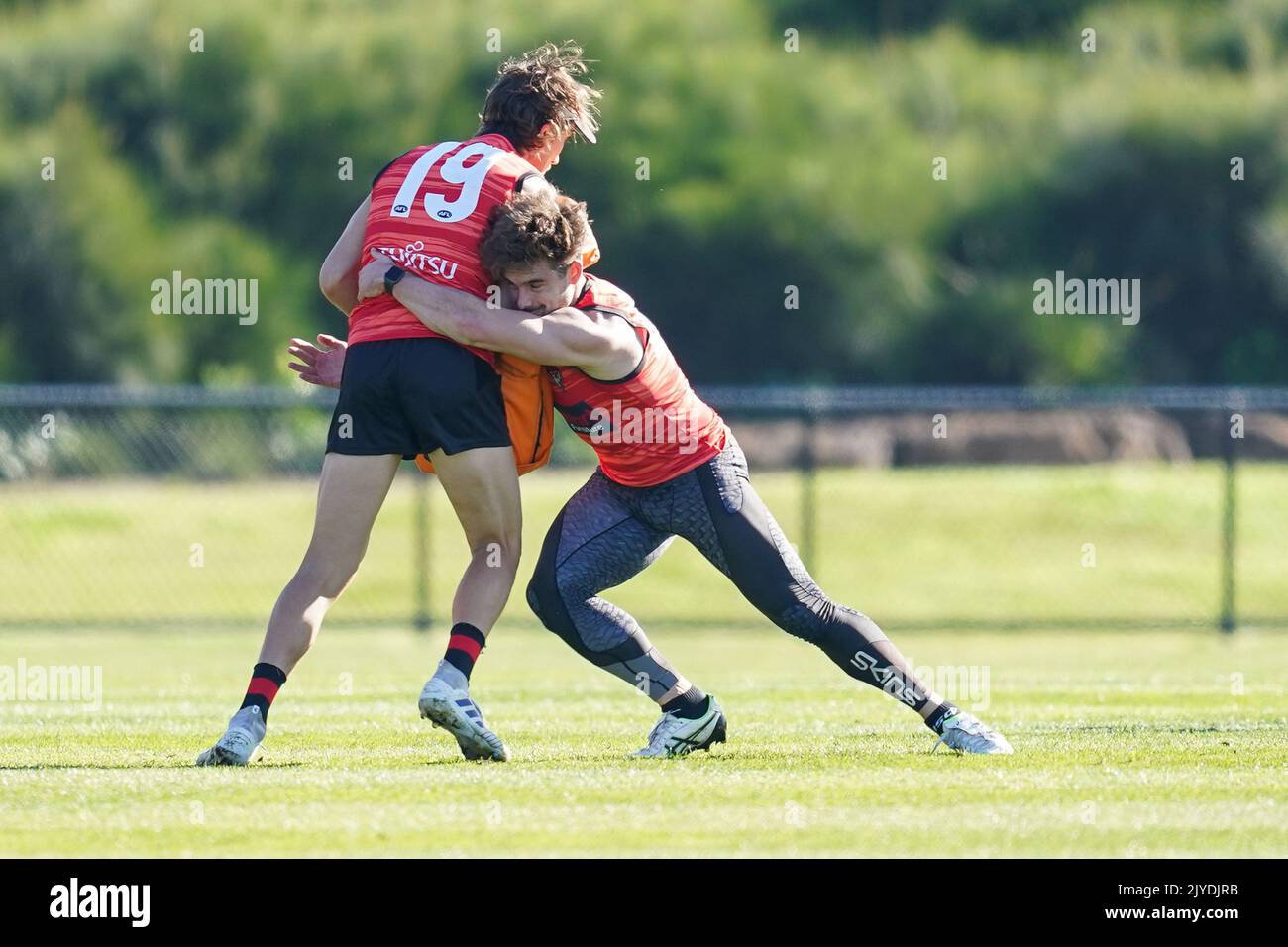 Will Snelling tackles Kobe Mutch during an AFL Bombers training session ...