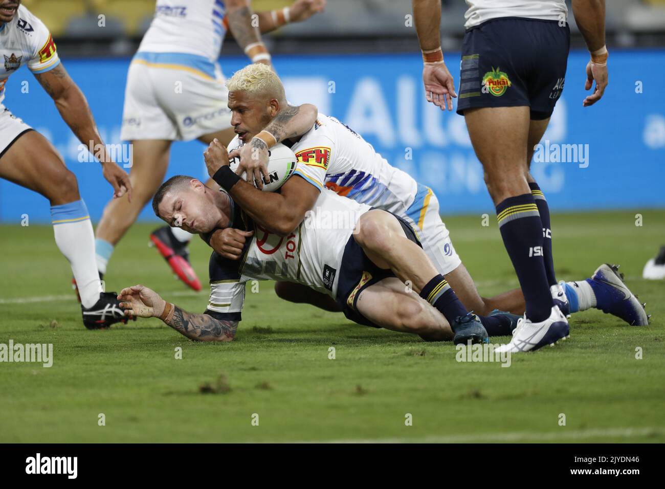 Ben Hampton of the Cowboys is tackled by Jonas Pearson during the Round ...