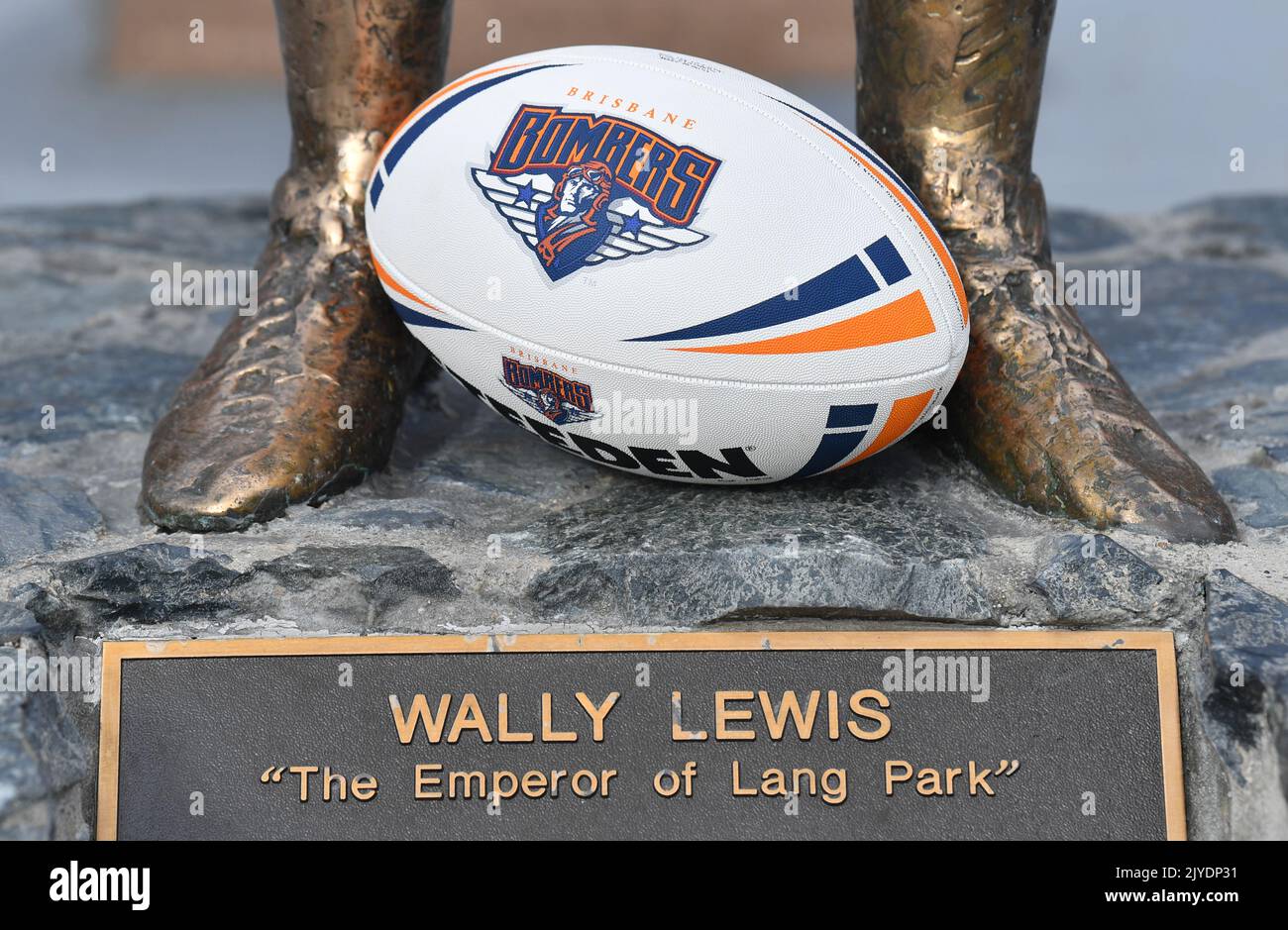 A football with the Brisbane Bombers NRL team logo is seen at the feet ...