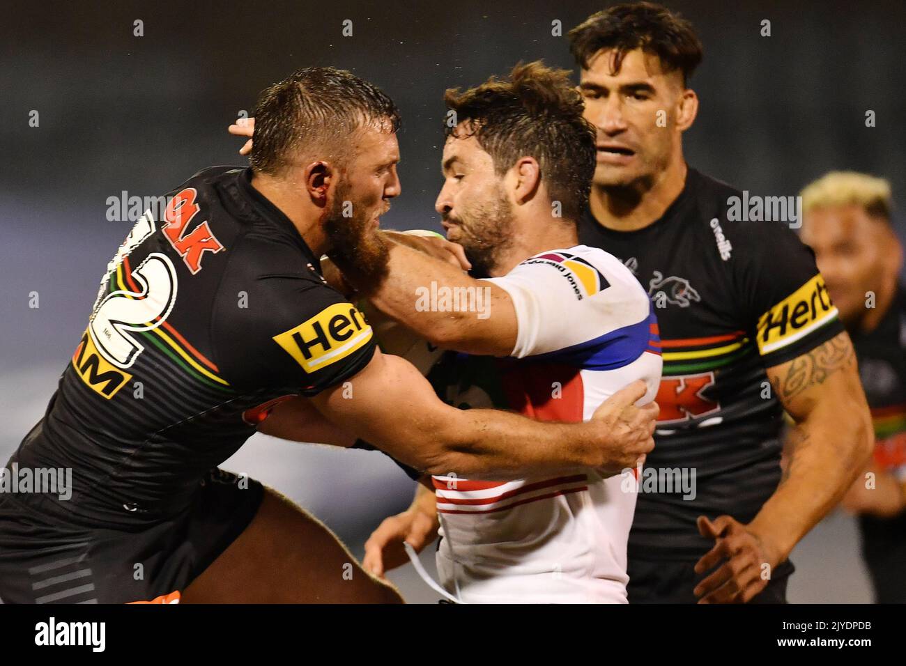 Aidan Guerra of the Knights tries to fend off a tackle by Kurt Capewell ...