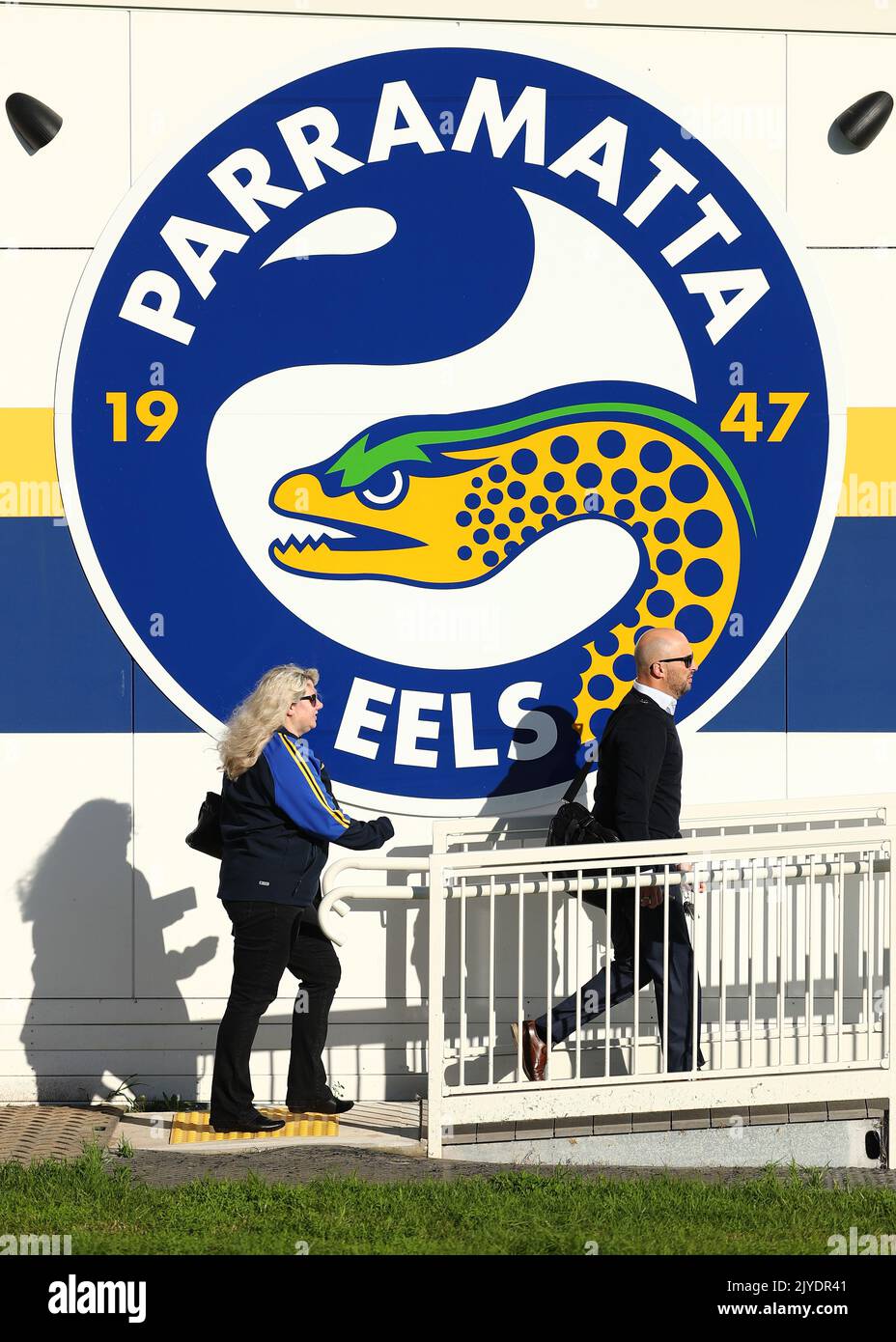 Club officials walk past a Parramatta Eels logo during a Parramatta ...
