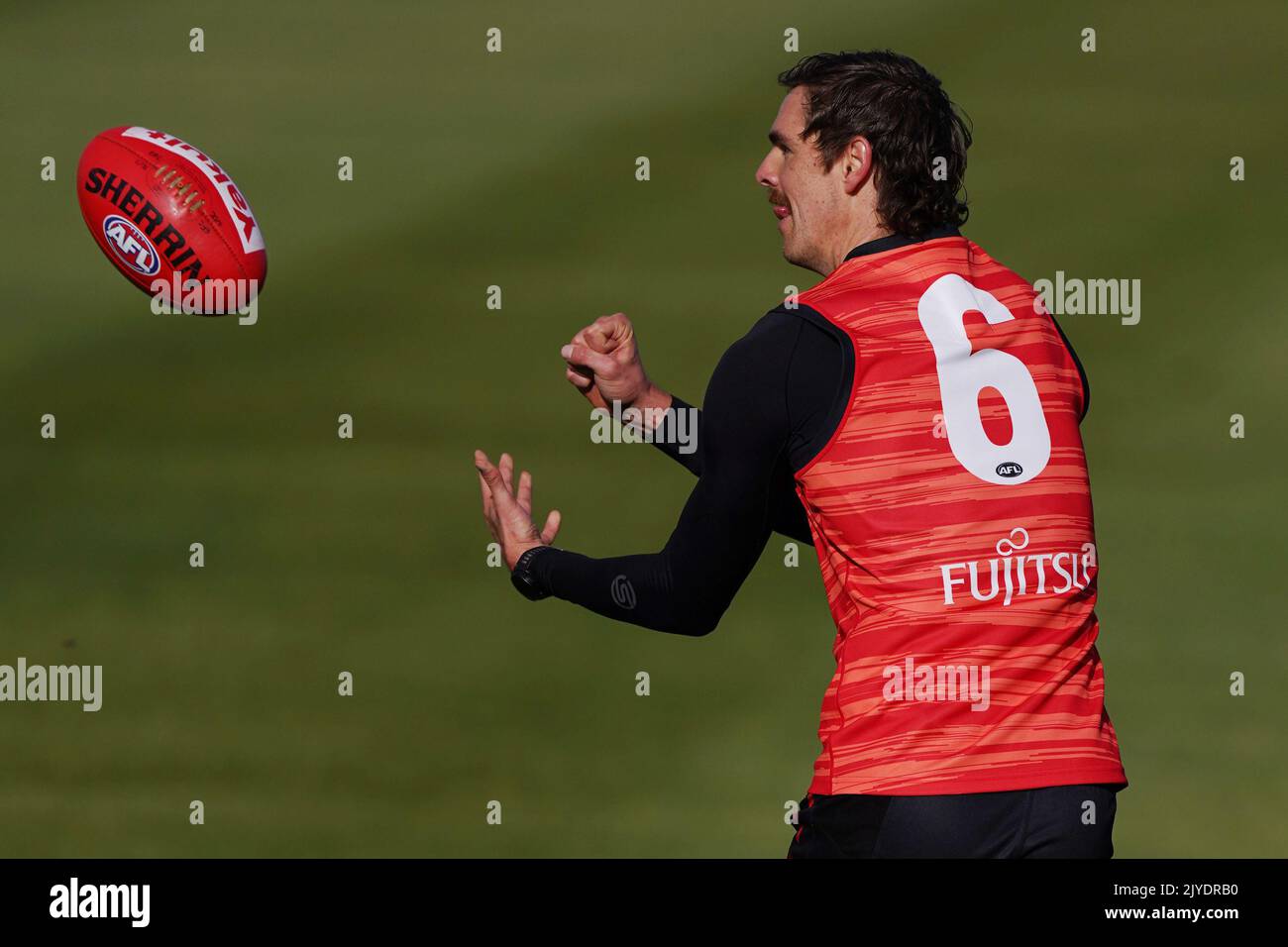 Joe Daniher of the Bombers handballs during an Essendon Bombers AFL ...