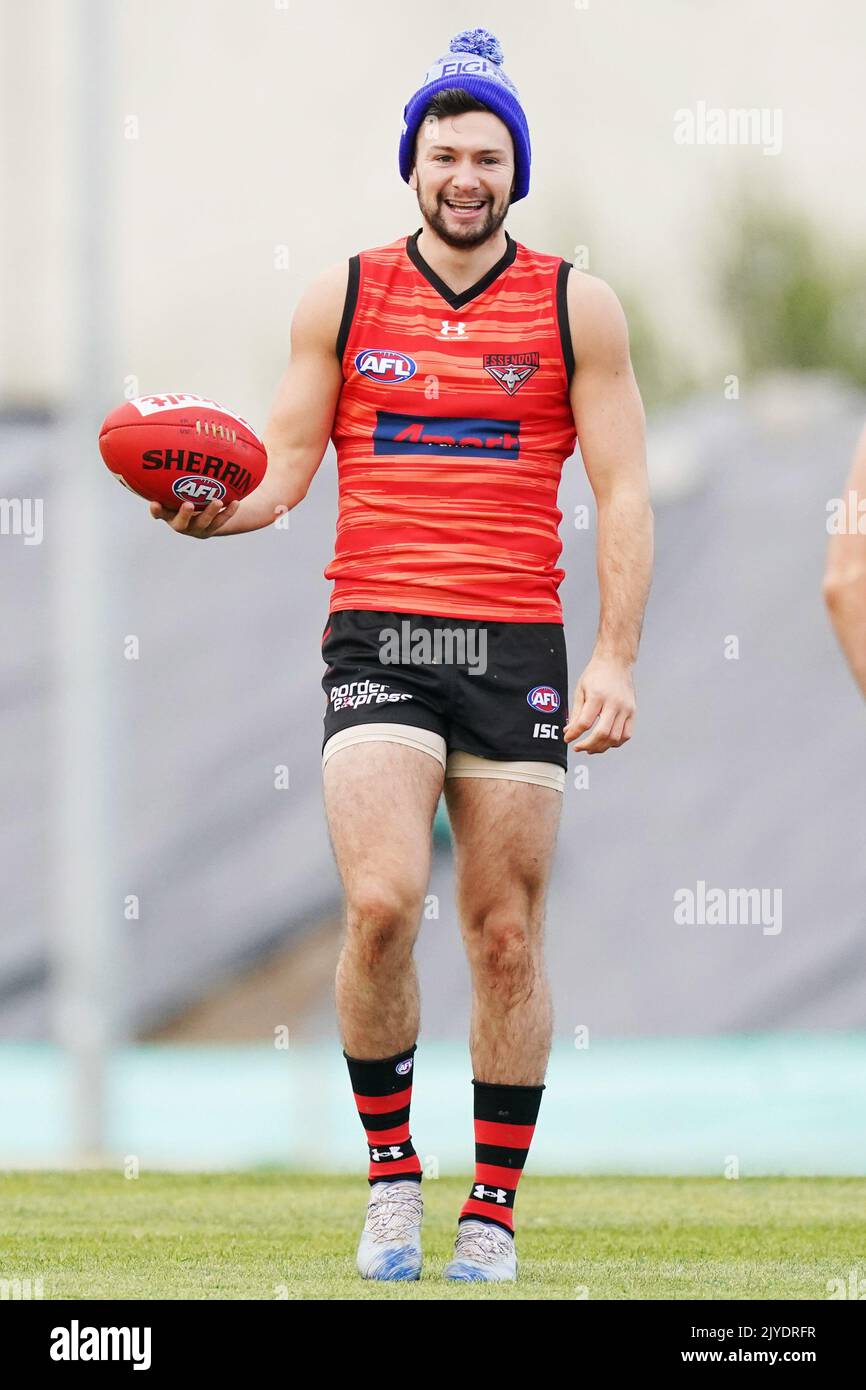 Conor McKenna of the Bombers stretches during an Essendon Bombers AFL ...
