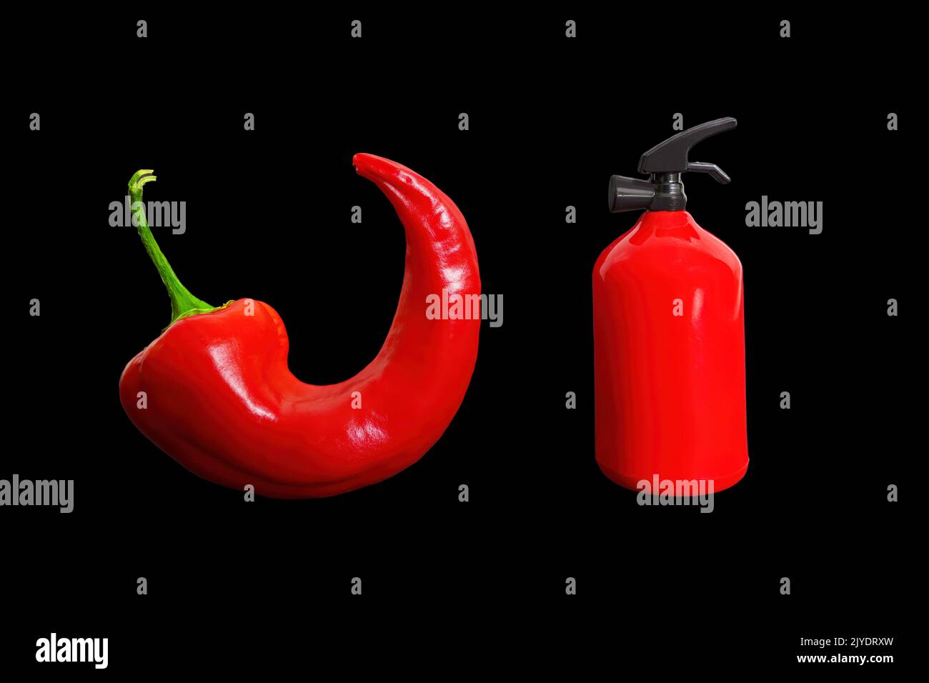 Curled red chili pepper and toy fire extinguisher isolated on black ...