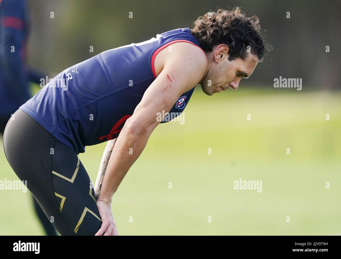 Harley Bennell rests during an AFL Melbourne Football Club training ...