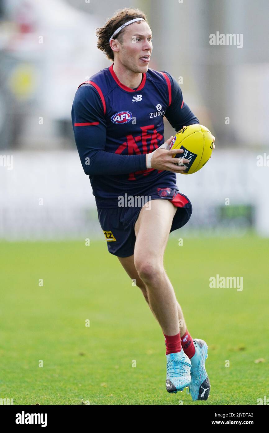 Ed Langdon of the Demons runs with the ball during an AFL Melbourne ...