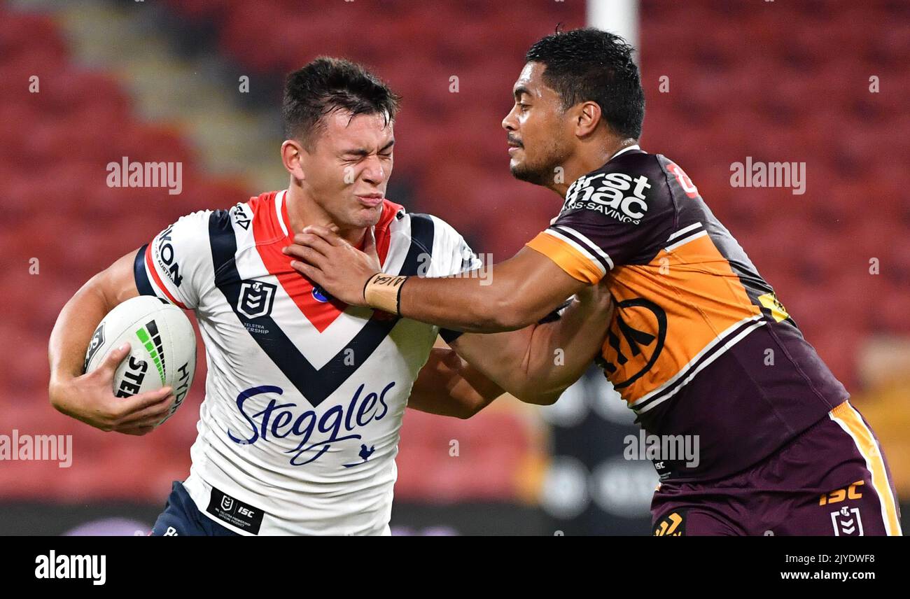 Joseph Manu (left) of the Roosters is tackled by Anthony Milford (right ...