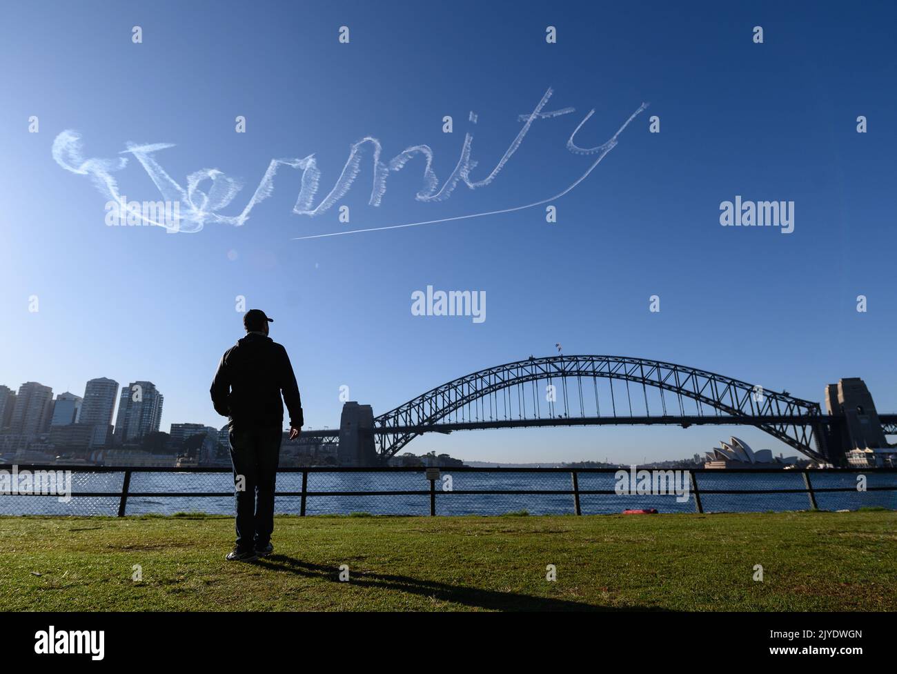 Passers by watch as the word of the millennium, ETERNITY, is written ...