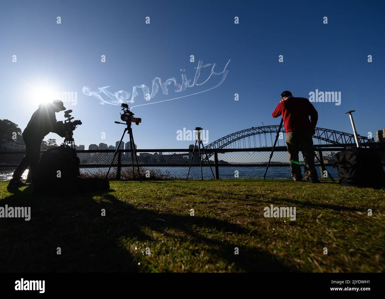 Camera crews watch as the word of the millennium, ETERNITY, is written ...