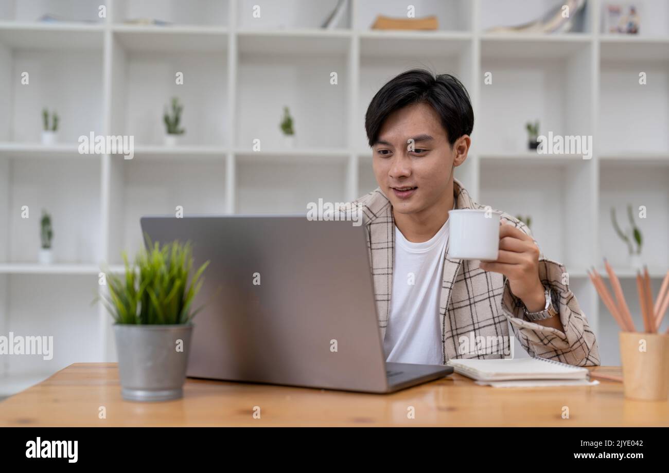Happy smiling asian student using laptop computer. Online learning ...