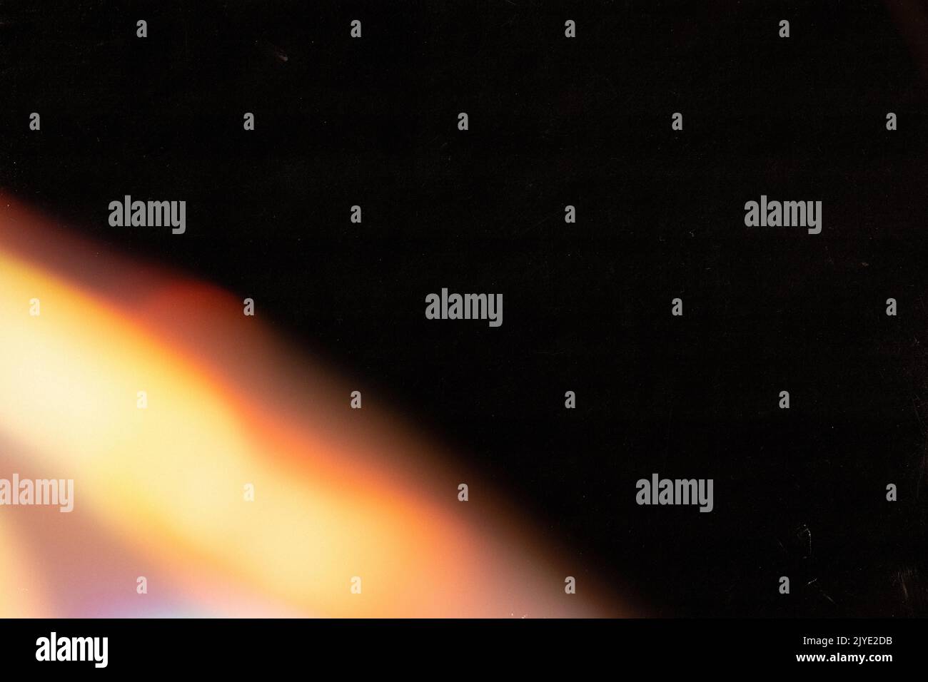 colorful warm rainbow light leaks on black background with dust texture ...