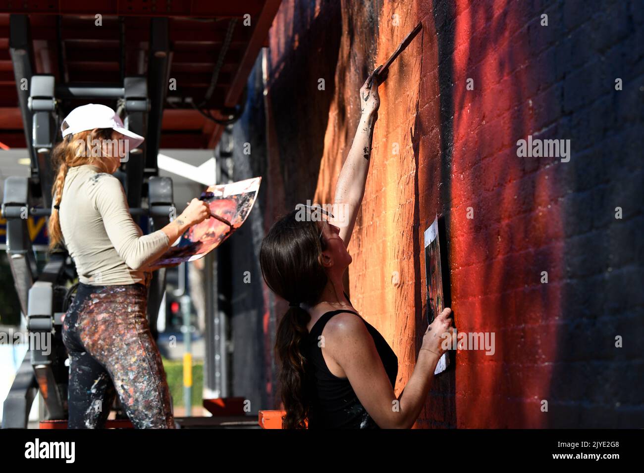 Artists paint a mural of former AFL player Adam Goodes in Surry Hills ...