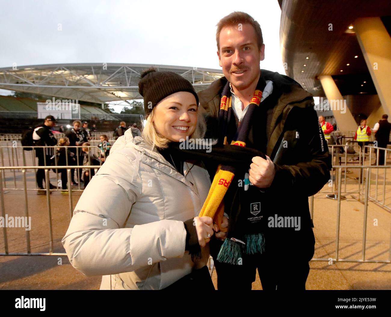 Port fan Carly Hann and Crows fan Daniel Robinson pose for a photograph ...