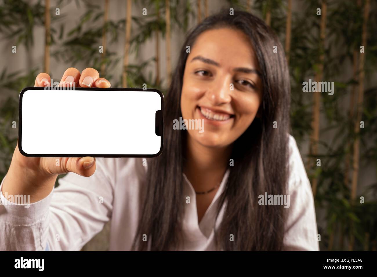 Showing phone screen, young caucasian beautiful woman showing phone ...