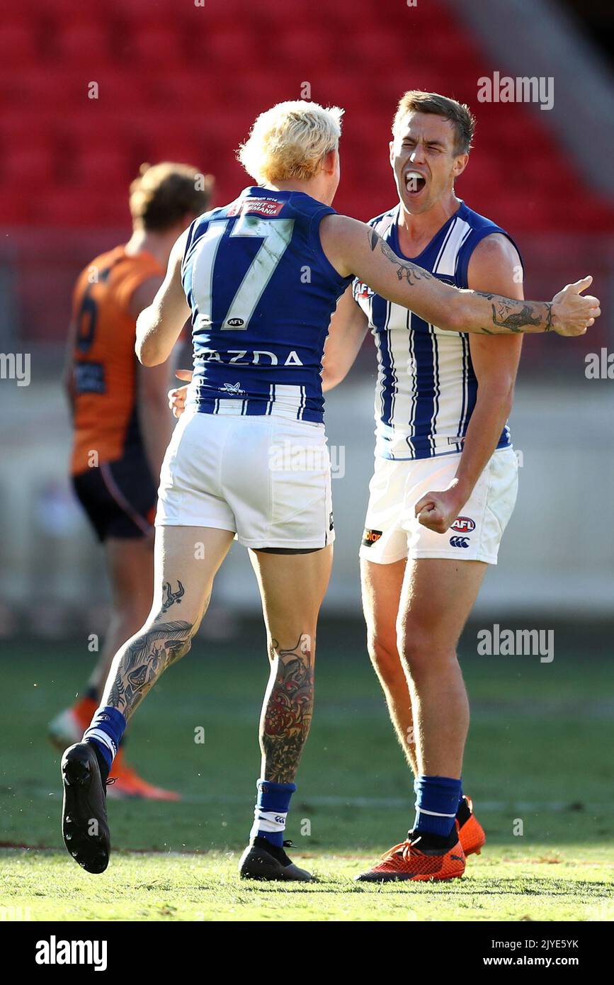 Jasper Pittard of the Kangaroos celebrates kicking a goal with team ...