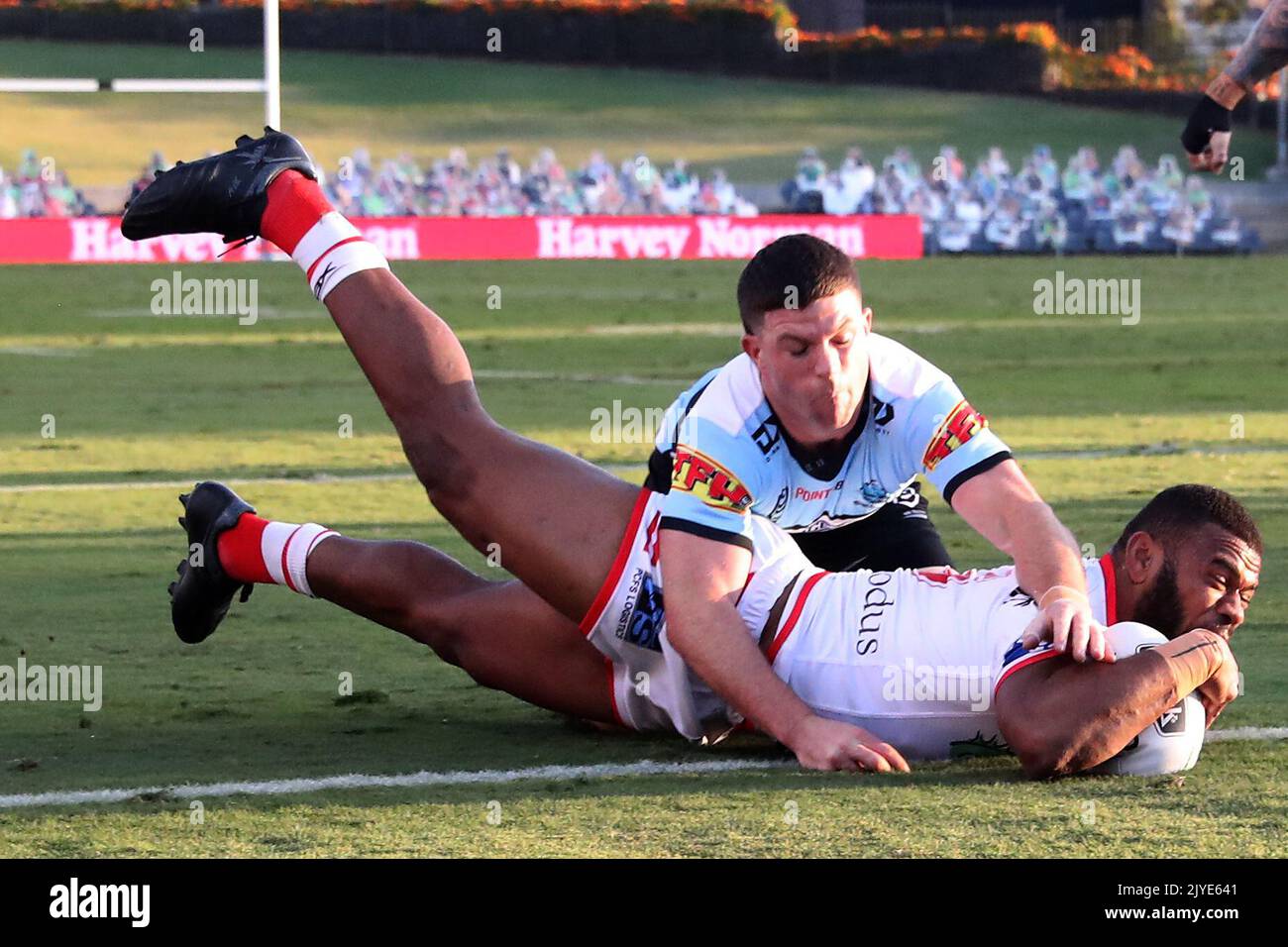Mikaele Ravalawa of the Dragons scores a try despite the efforts of ...