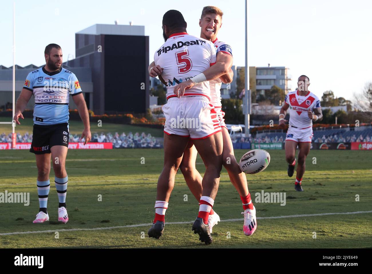 Mikaele Ravalawa of the Dragons celebrates his try with Zac Lomax of ...