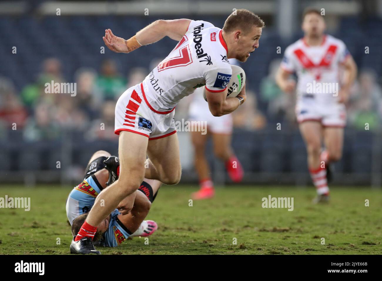 Matthew Duffy of the Dragons escapes a tackle by Wade Graham of the ...