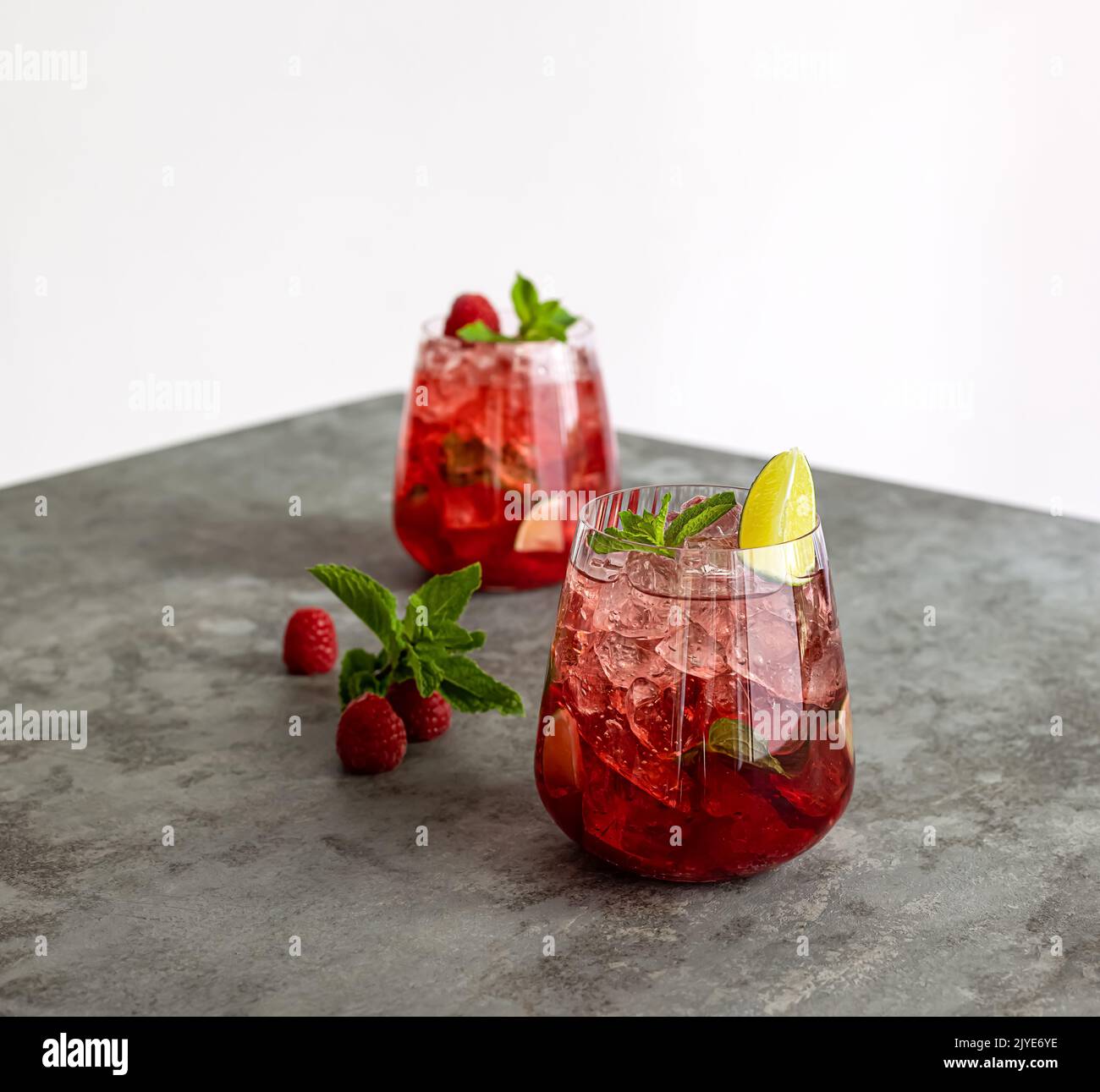 Bourbon or rum raspberry smash cocktail with lime and mint. Refreshing cold drink Stock Photo ...