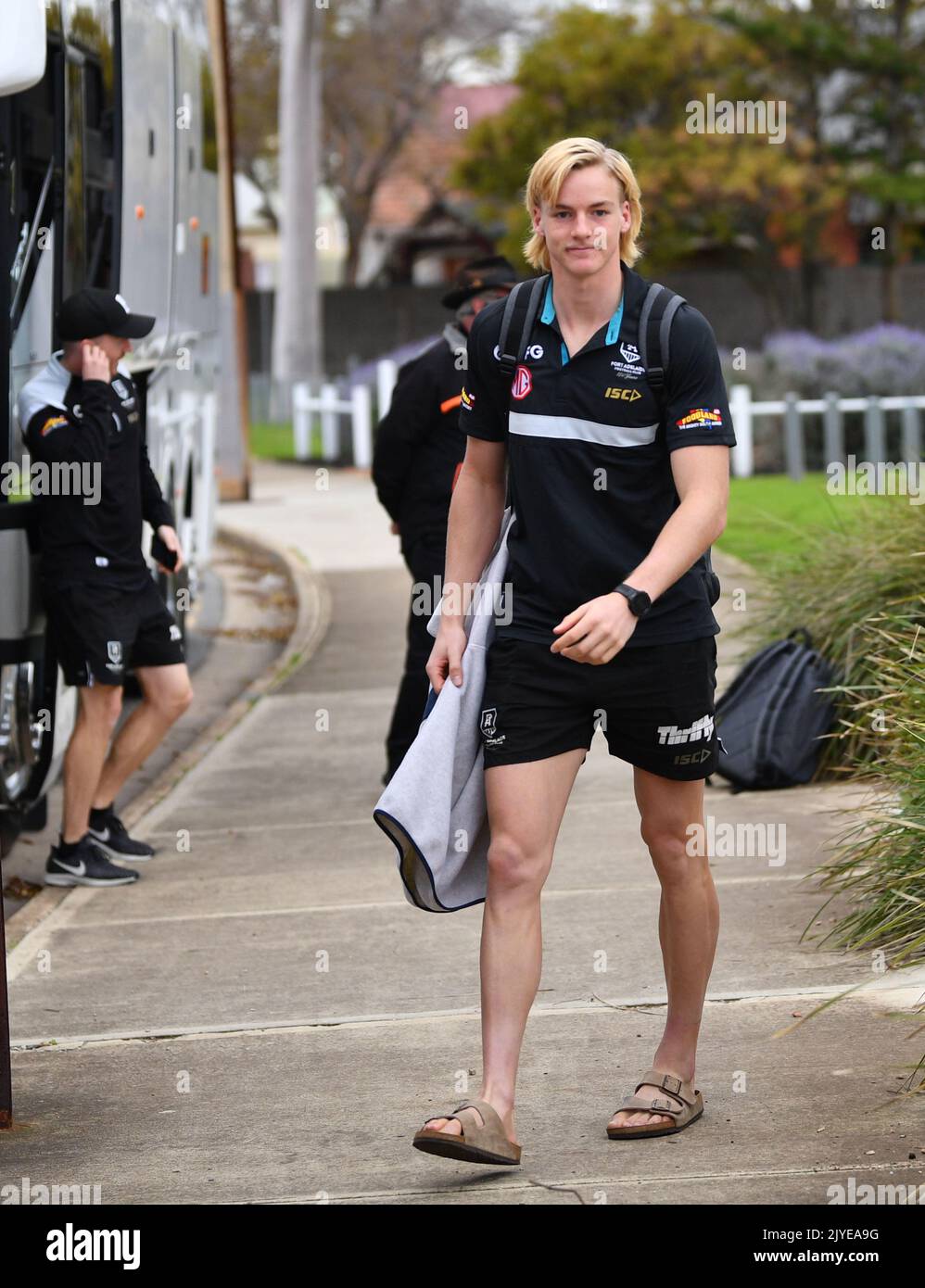 Miles Bergman of the Power board's a bus at Alberton Oval in Adelaide ...