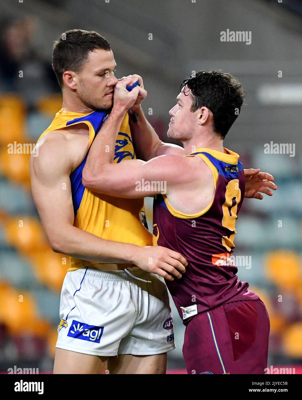 Jack Redden (left) of the Eagles is grabbed by Lachie Neale (right) of ...