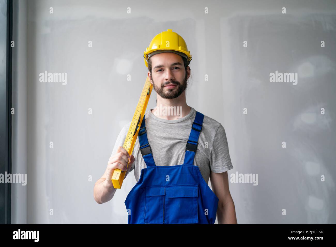 Portrait of male worker professional electrician in uniform installing ...