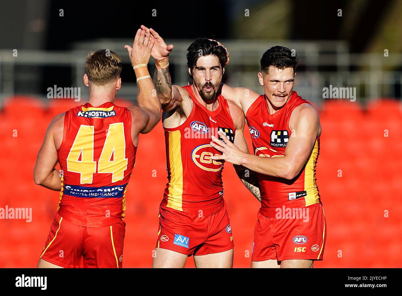 Alex Sexton of the Suns (centre) reacts after kicking a goal during the ...