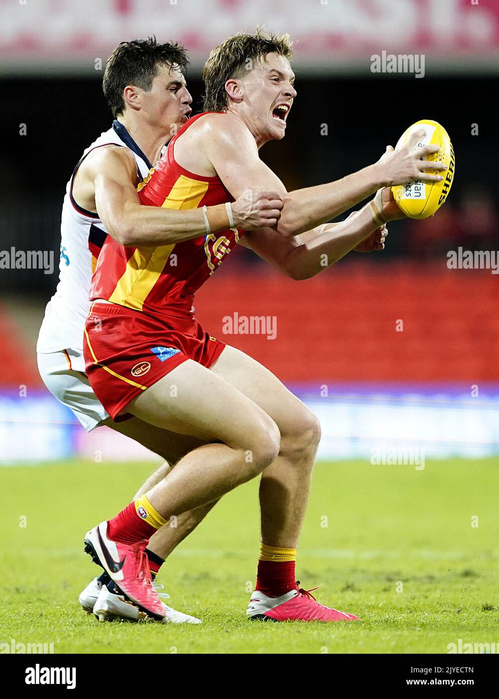Jake Kelly of the Crows tackles Noah Anderson of the Suns during the ...