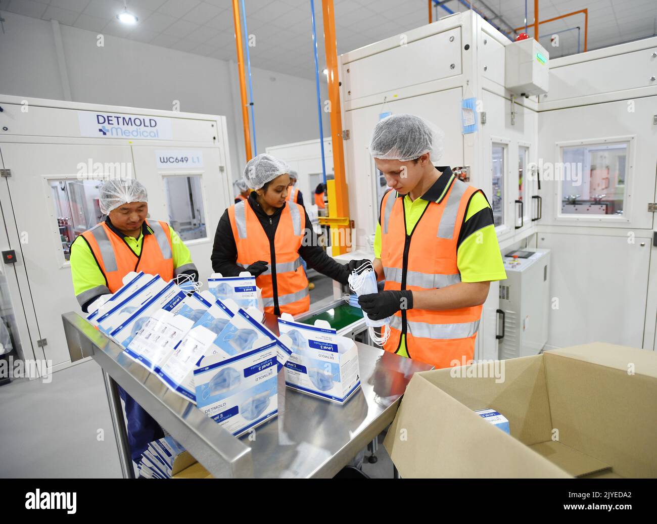 Employees on the production line of the Detmold PPE production facility ...