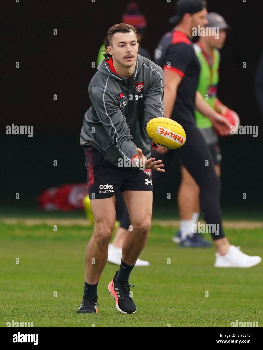 Sam Draper runs with the ball during an Essendon Bombers AFL training ...