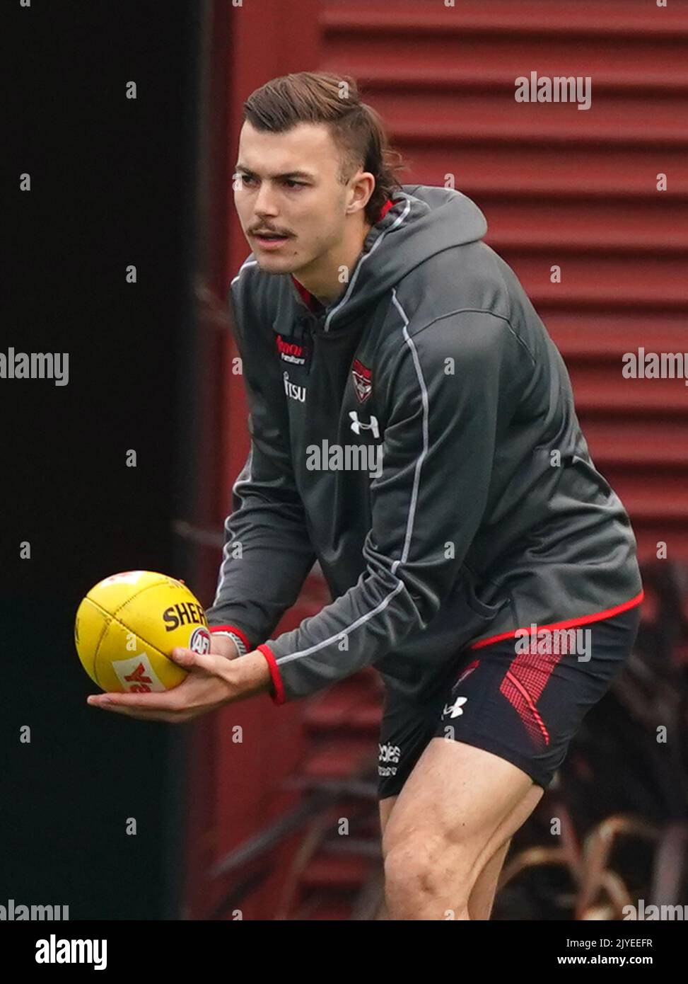 Sam Draper runs with the ball during an Essendon Bombers AFL training ...
