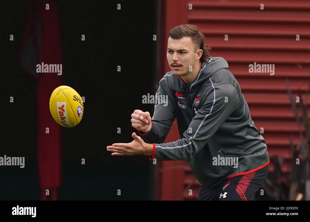 Sam Draper runs with the ball during an Essendon Bombers AFL training ...