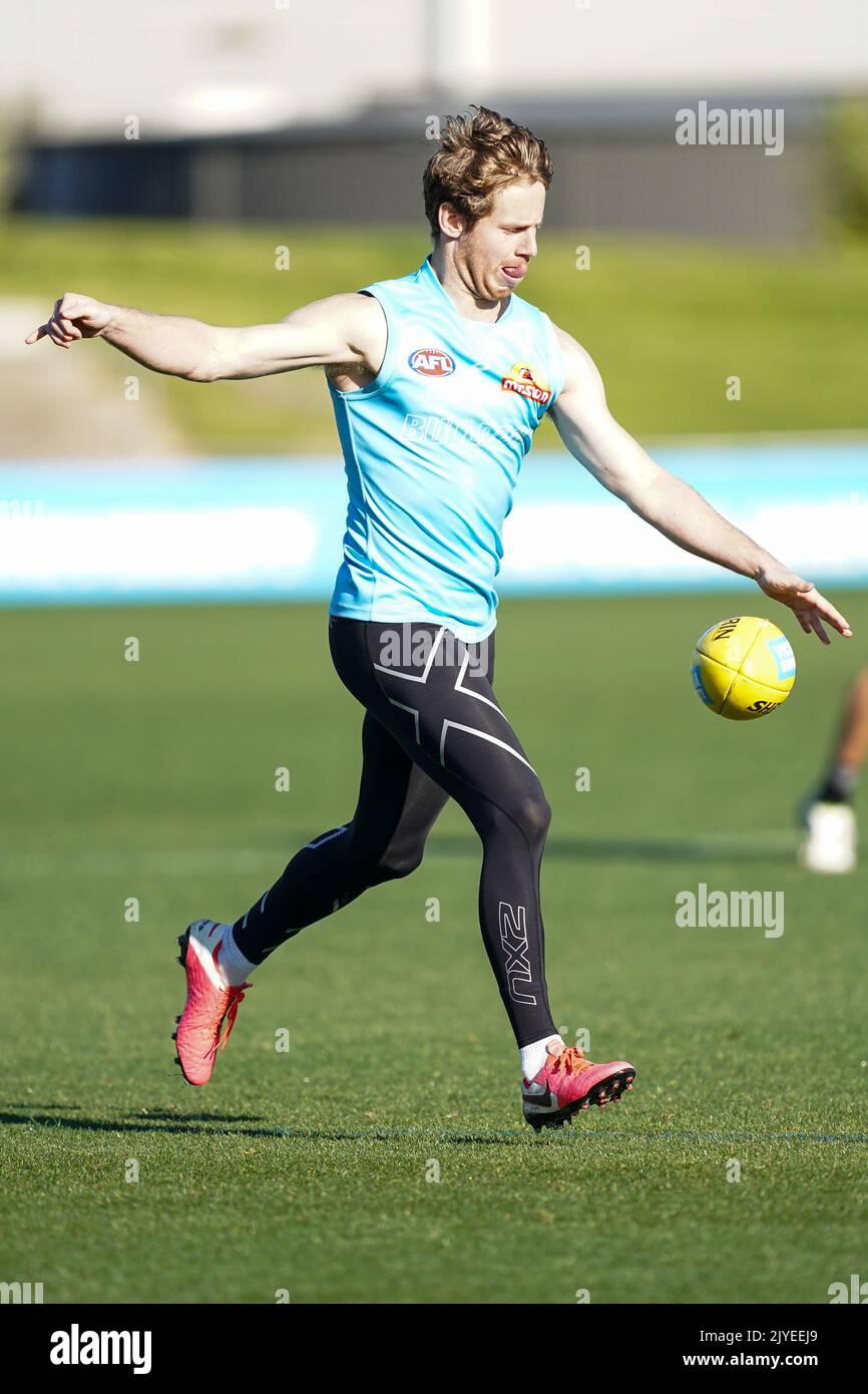 Lachie Hunter kicks the ball during an AFL Bulldogs training session at ...