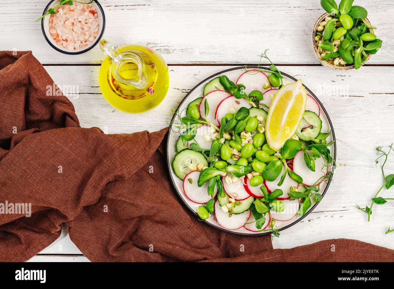 Fresh salad with radish, cucumber, green pea, sunflower, soy and mung ...