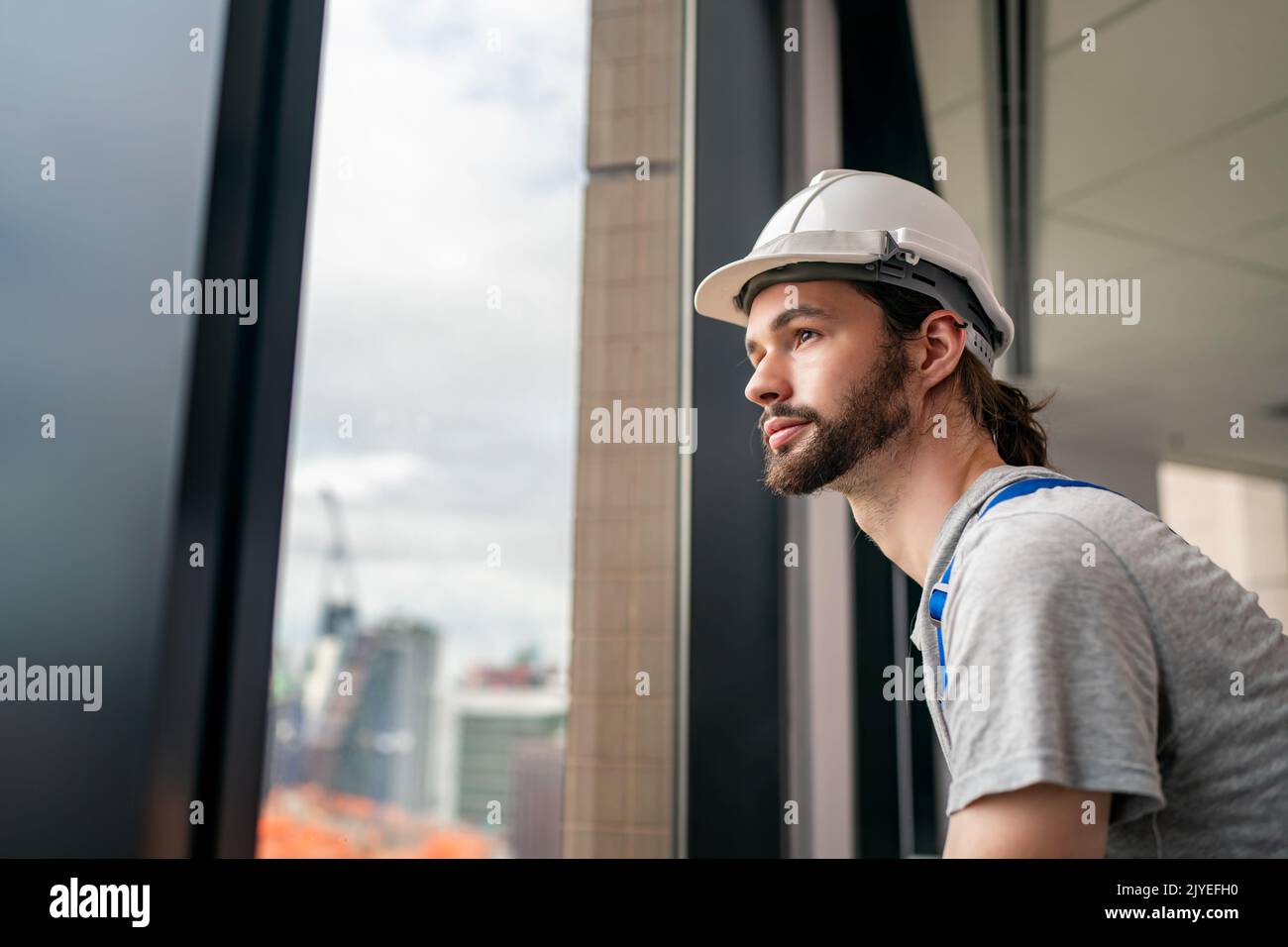 Portrait of male worker professional electrician in uniform installing ...