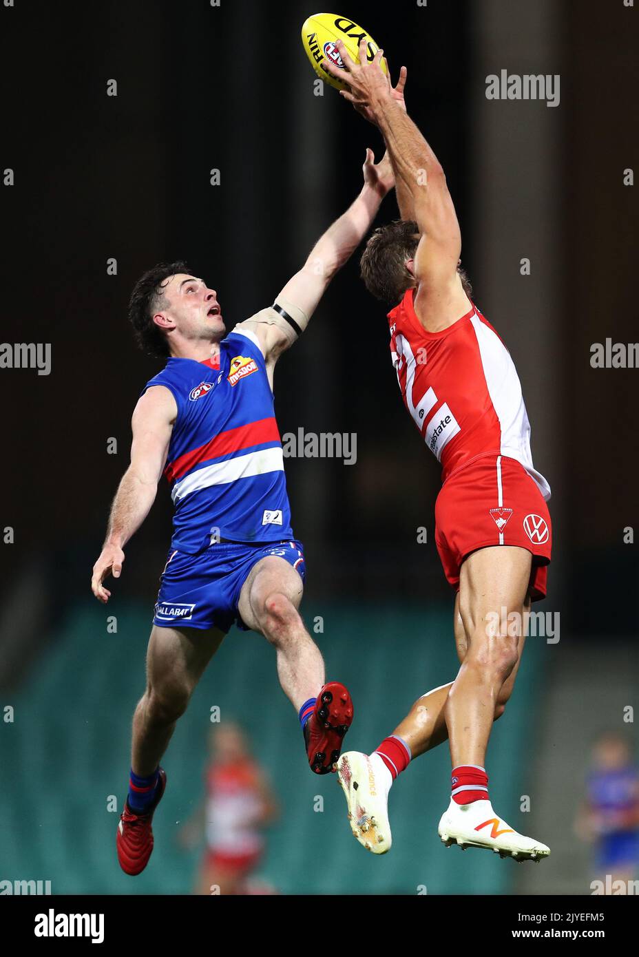 Josh Kennedy of the Swans contests the ball with Toby McLean of the ...