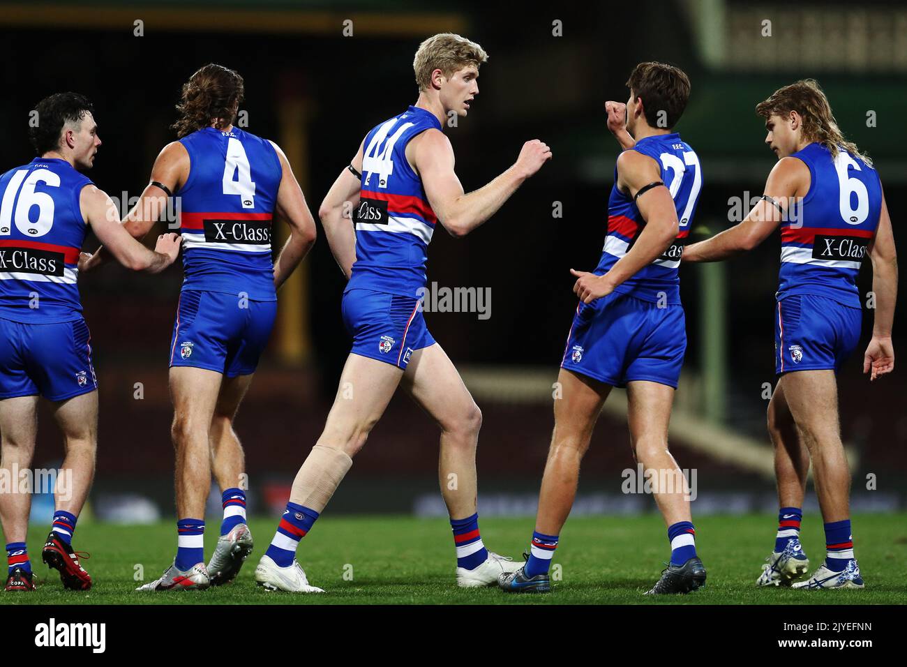 Tim English of the Bulldogs celebrates kicking a goal with team mates ...