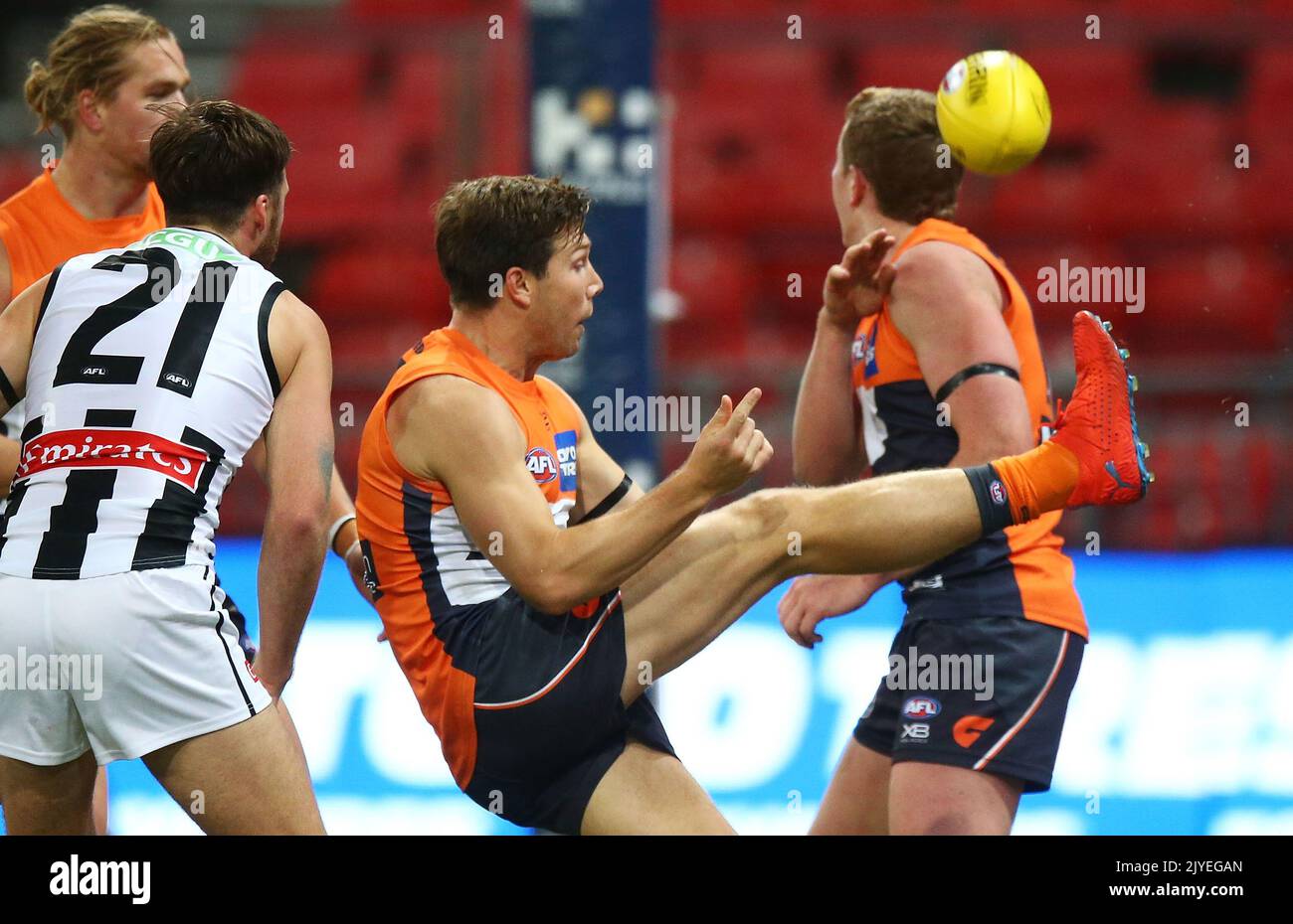 Toby Greene of the Giants kicks for goal with team mates during the ...