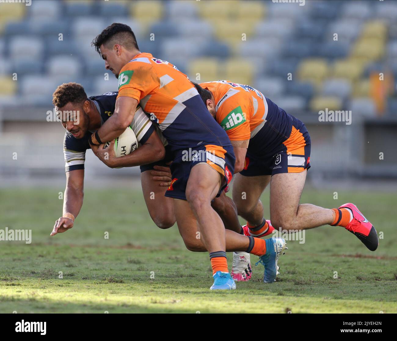 Hamiso Tabuai-Fidow of the Cowboys is tackled by Aidan Guerra and Enari ...