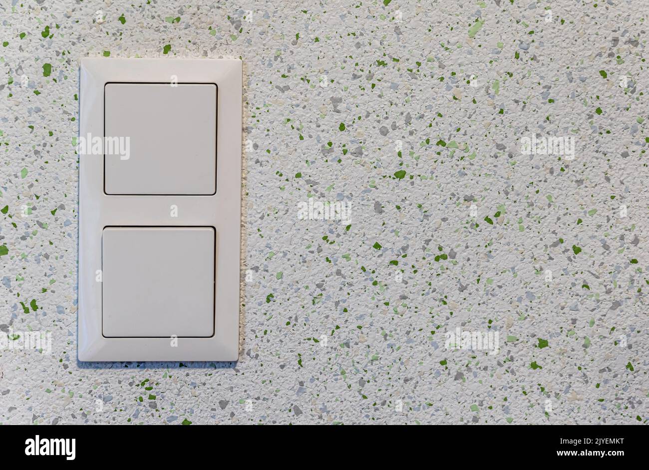 Light switch on an interior wall with speckled wall design with spray ...