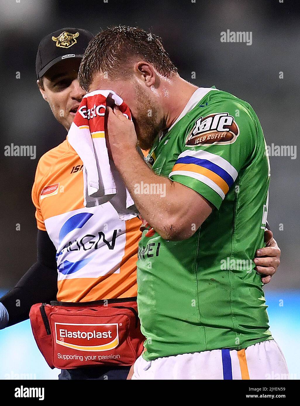 Elliott Whitehead of the Raiders is assisted from the field after ...