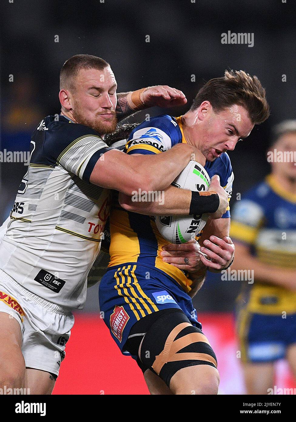 Clint Gutherson of the Eels is tackled by Coen Hess of the Cowboys ...