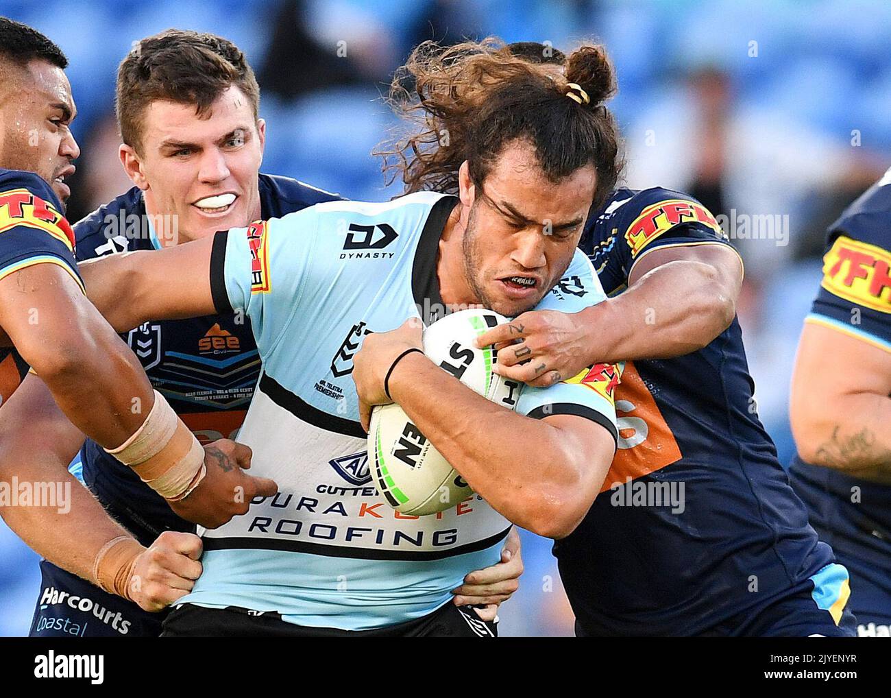 Toby Rudolf of the Sharks is tackled during the Round 8 NRL match ...